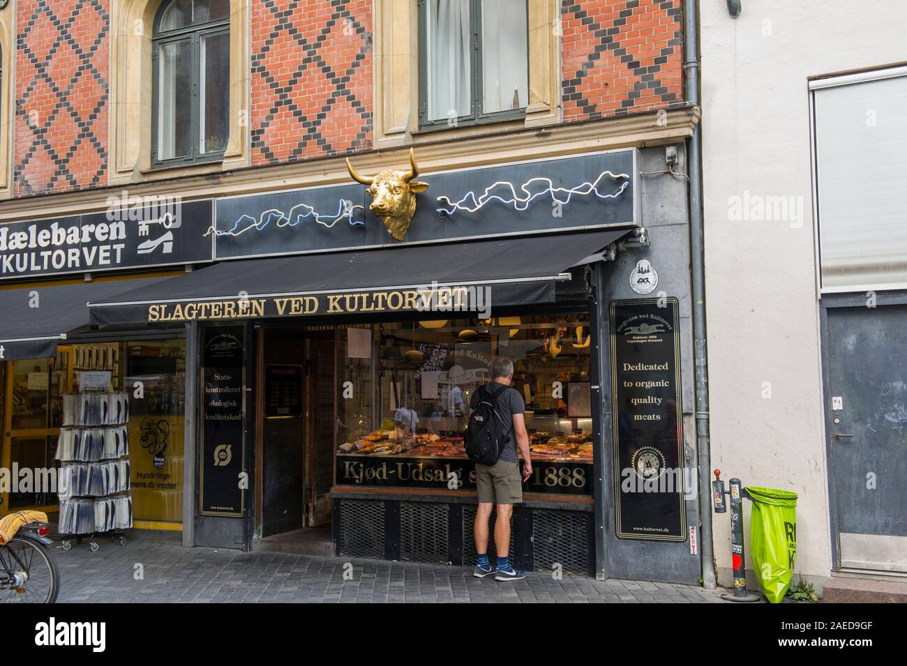 A man looking through the window of a butcher's shop in Copenhagen ...