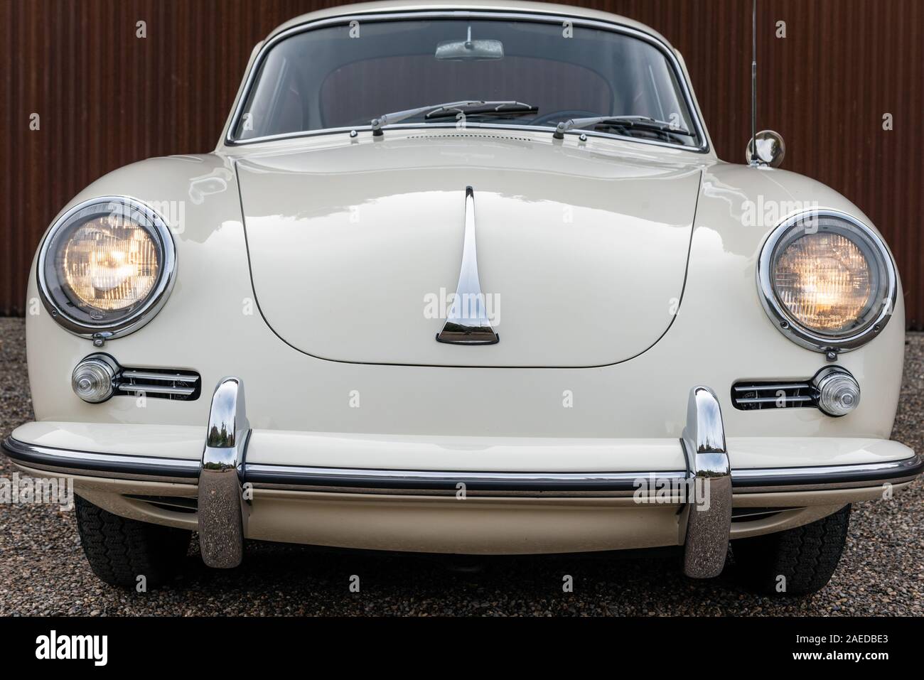 Shiny vintage classic car reflects the world around with headlights ...