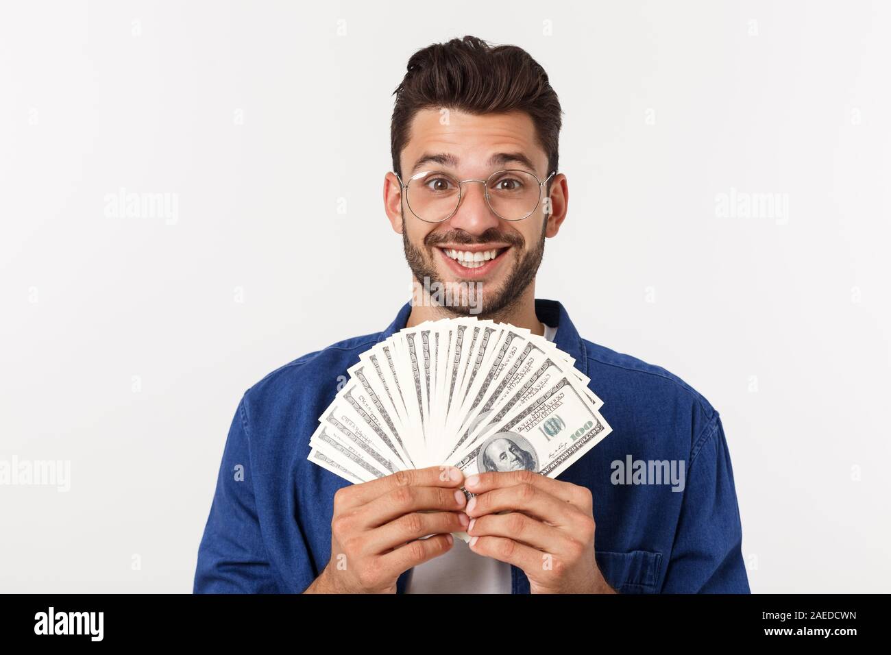 Attractive man is holding cash money in one hand, on isolated white ...