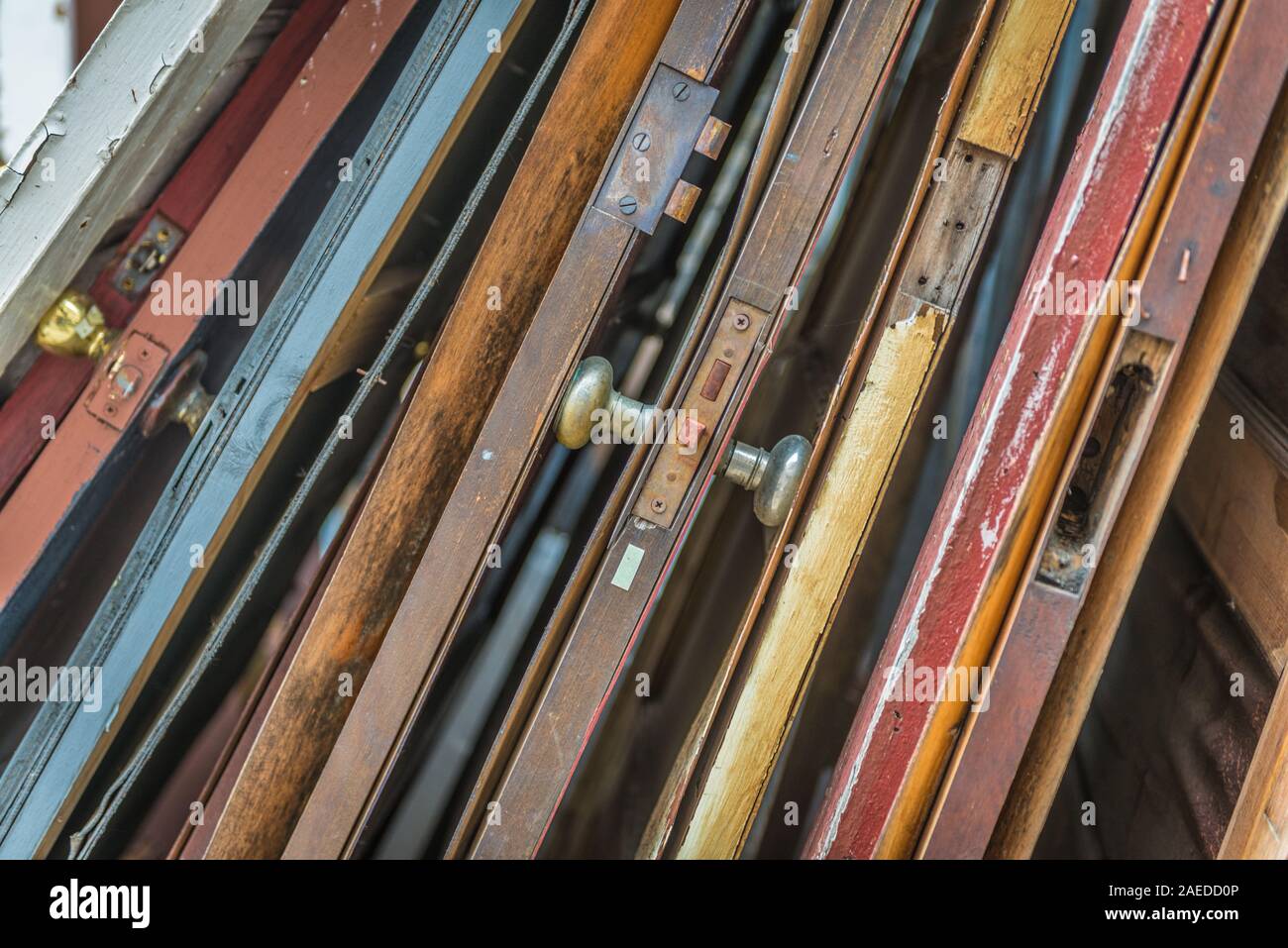 Several doors lean against a wall and are seen edge-on Stock Photo - Alamy