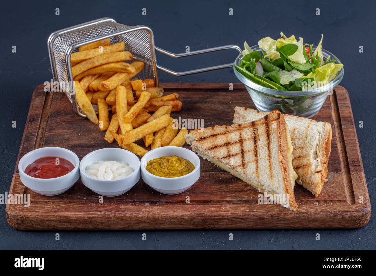Cheddar Toast served with french fries on cutting board Stock Photo - Alamy