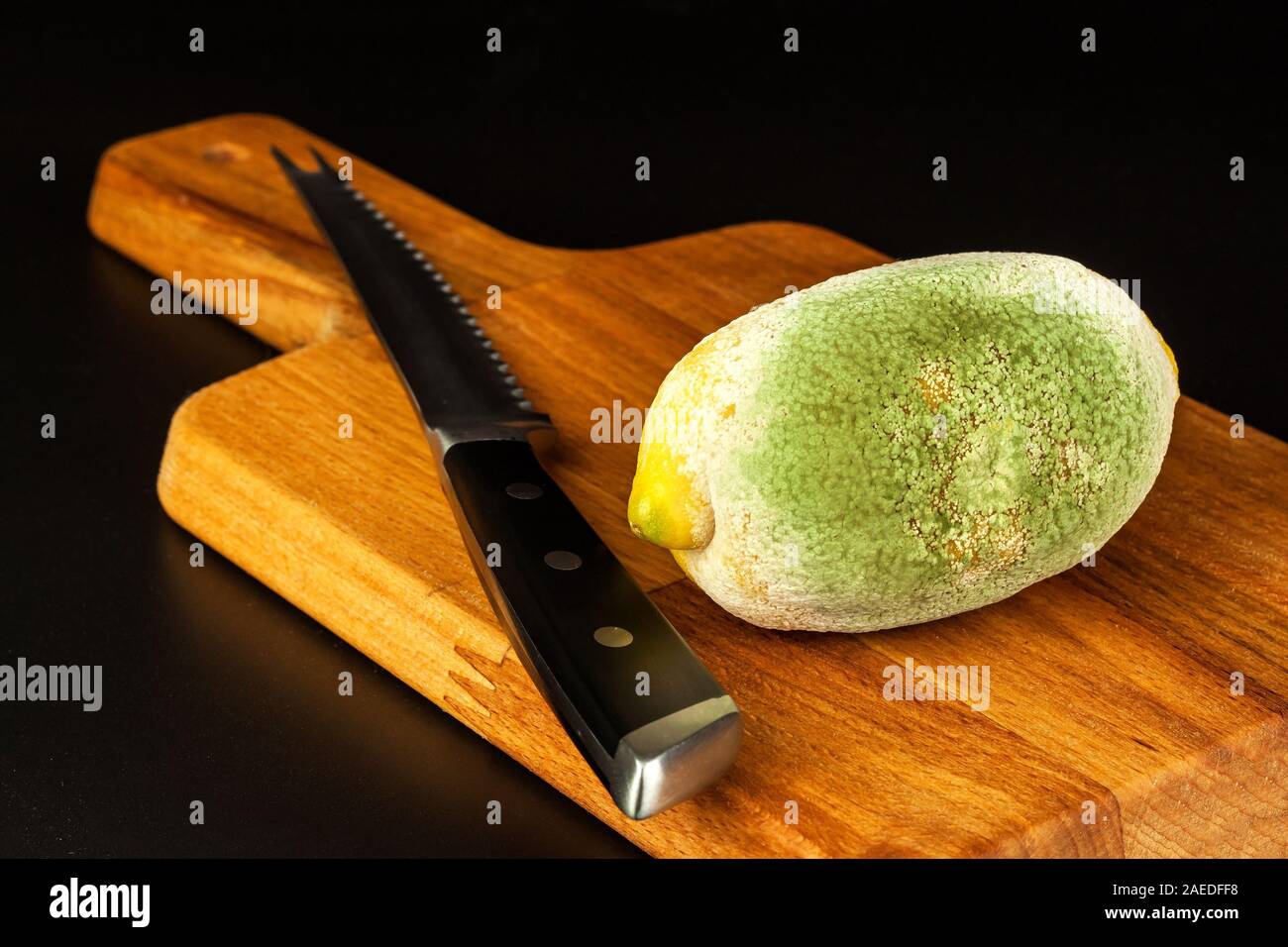 Moldy lemon on a kitchen board. Unhealthy food. Decayed fruit. Moldy ...