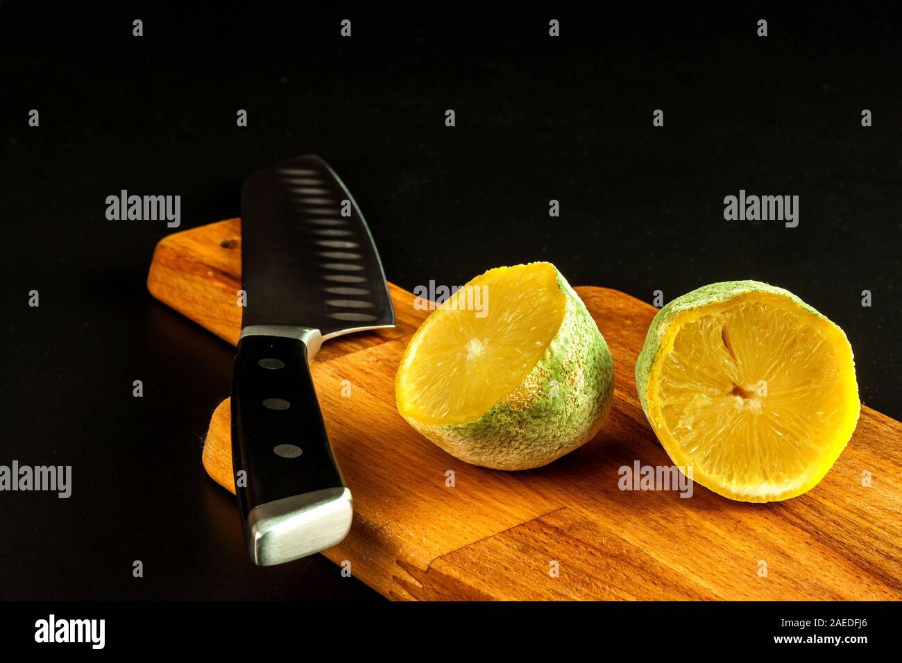 Moldy lemon on a kitchen board. Unhealthy food. Decayed fruit. Moldy ...
