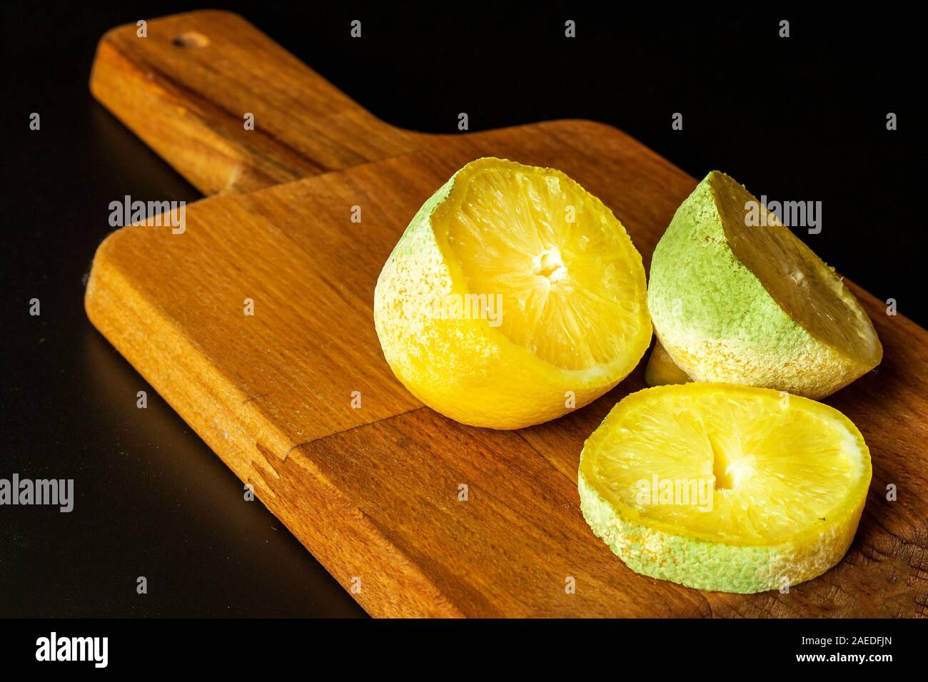 Moldy lemon on a kitchen board. Unhealthy food. Decayed fruit. Moldy ...