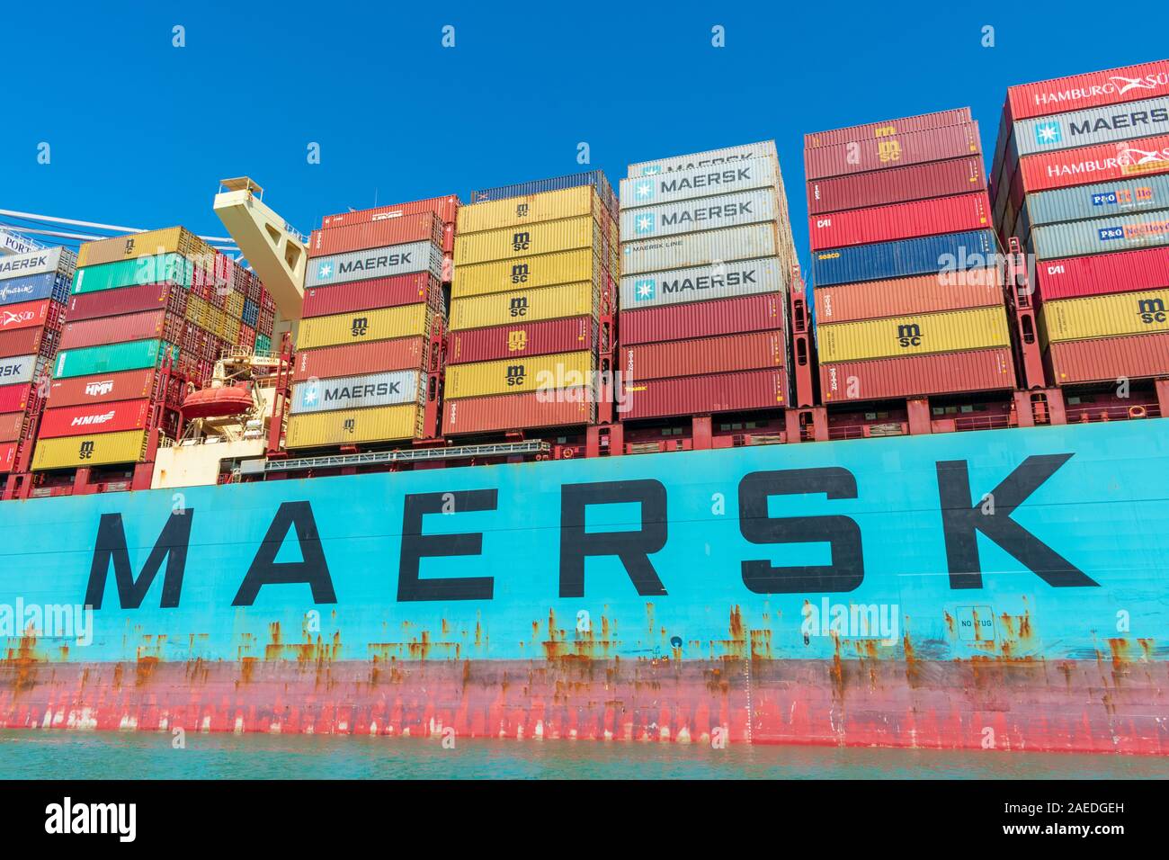 Colorful cargo shipping containers stacked aboard of container ship ...