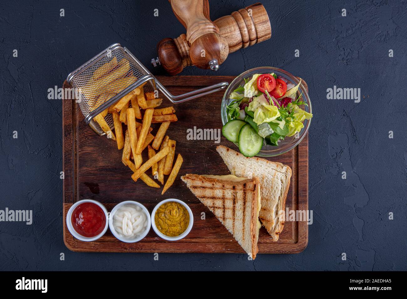 Cheddar Toast served with french fries on cutting board Stock Photo - Alamy