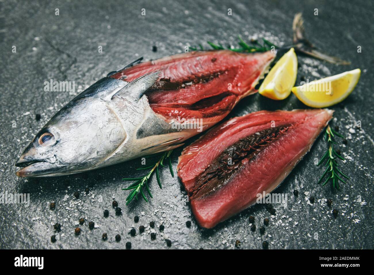Fresh fish fillet sliced for steak or salad with herbs spices rosemary ...