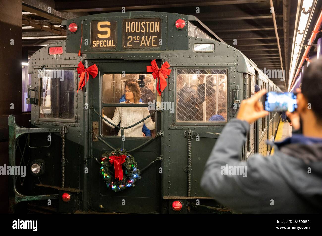 New York, USA. 8th Dec, 2019. People take a ride in a vintage subway car during Holiday ...