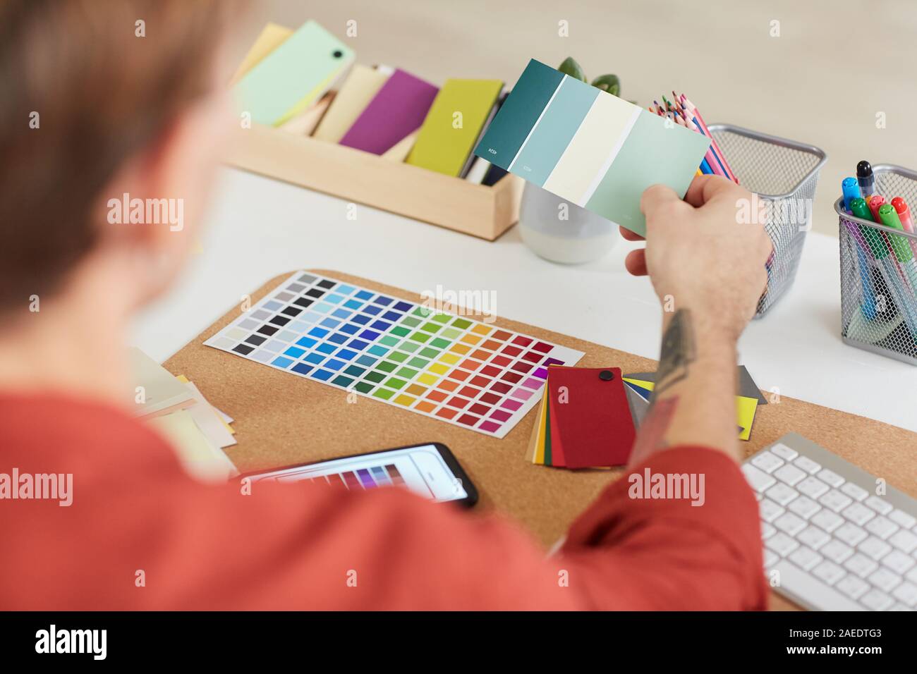 Close up of male designer choosing color palette while planning ...