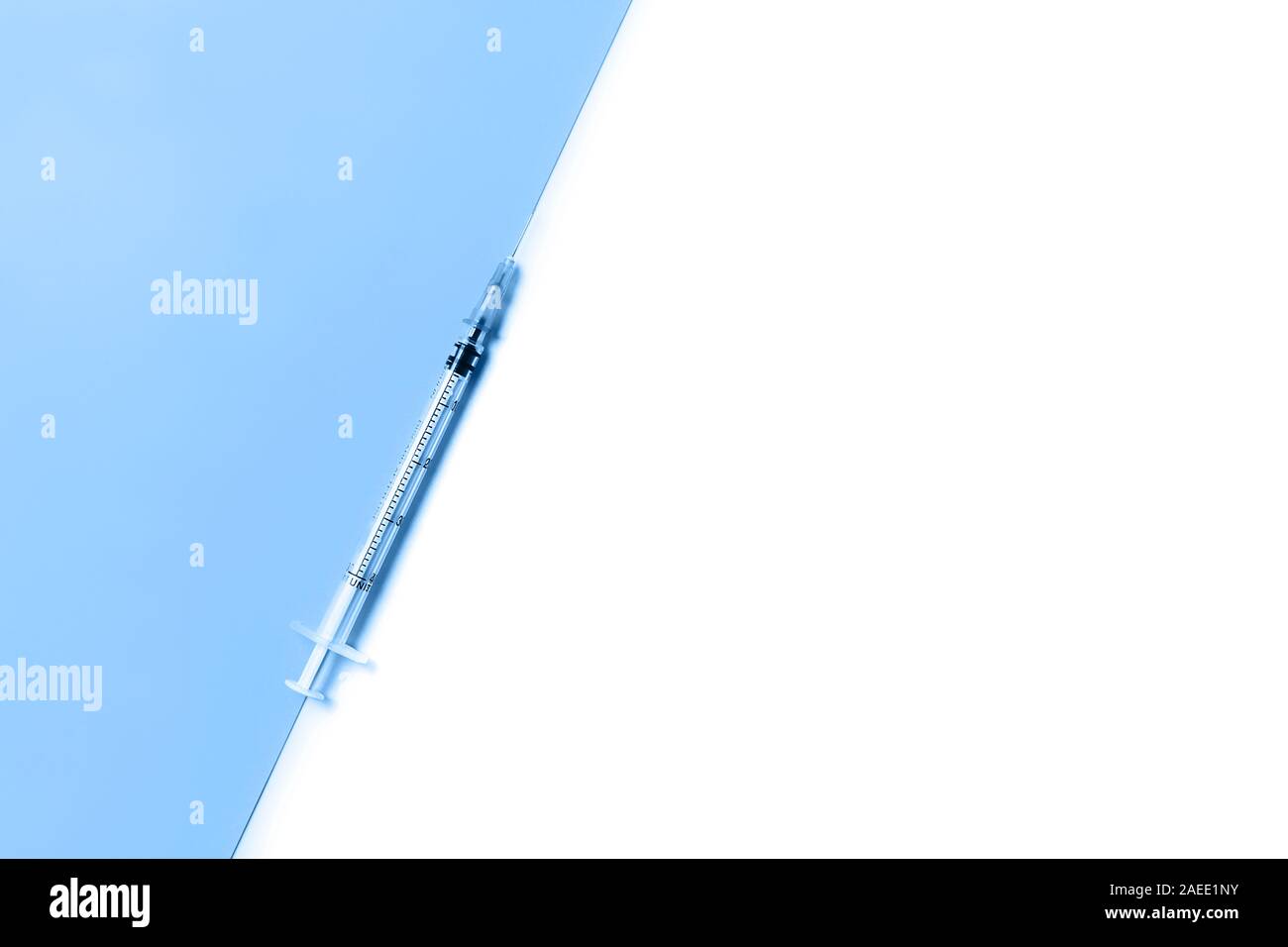 Empty syringe on trendy blue and isolated white background. Flat lay ...