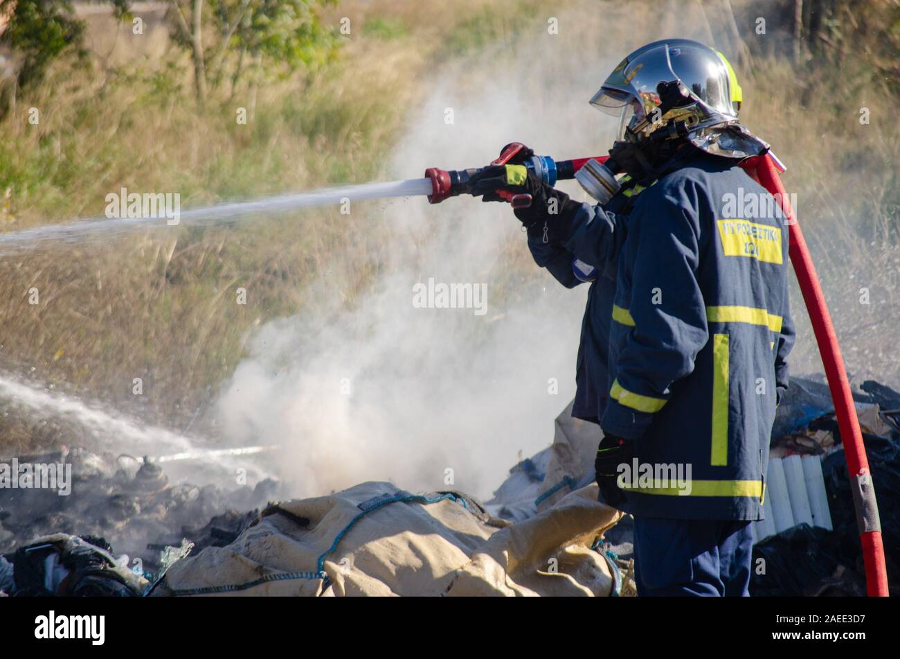Menidi Athens Greece December 18 2019: Firemen douse burning trash ...