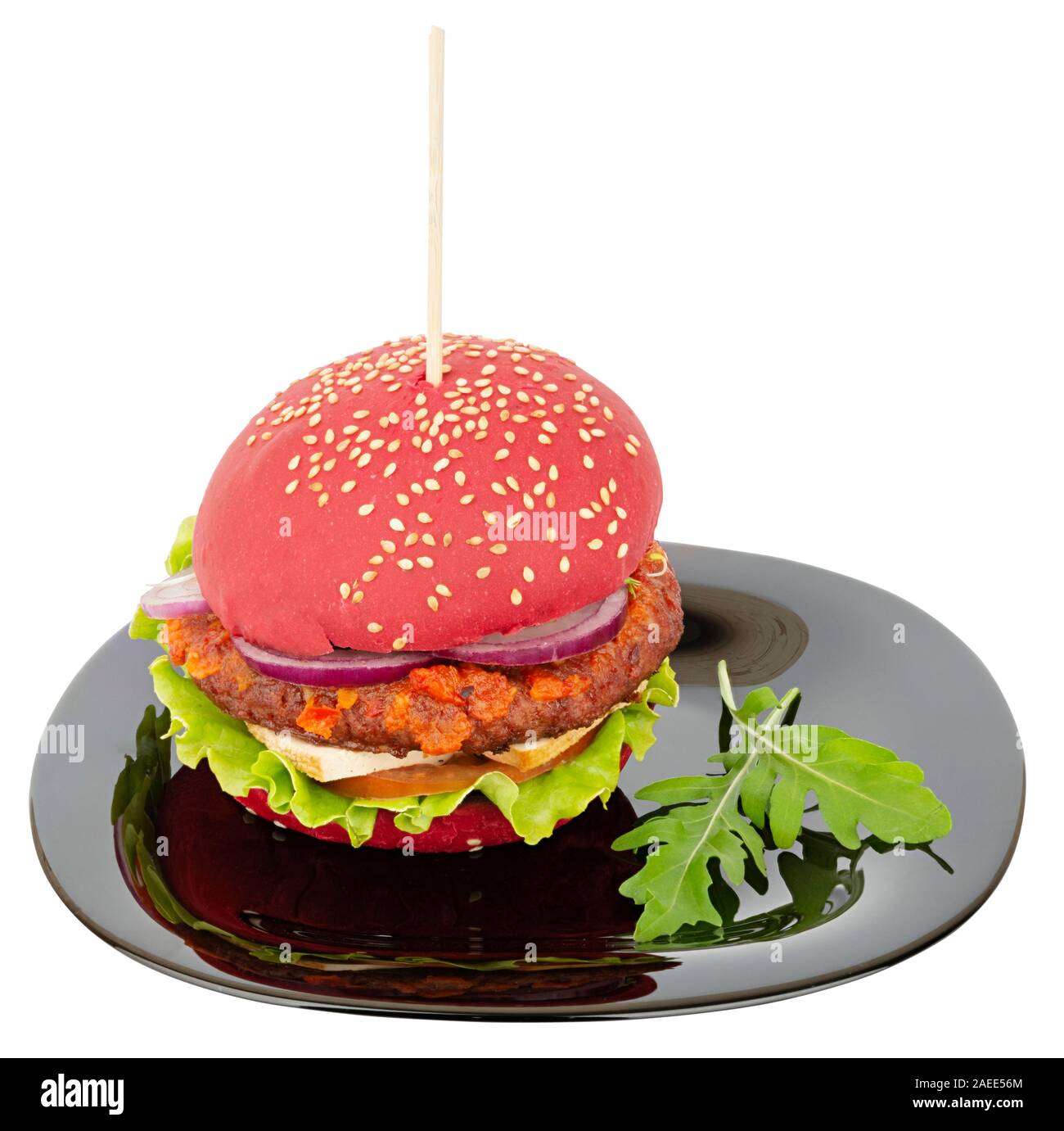 Red bun vegan burger with rucola on a plate isolated on white ...