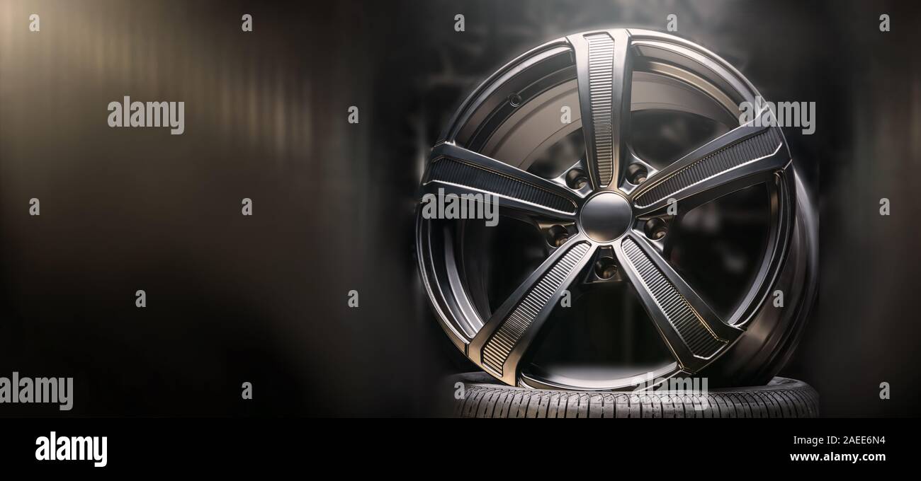 beautiful black alloy wheels made of aluminum on a dark background ...