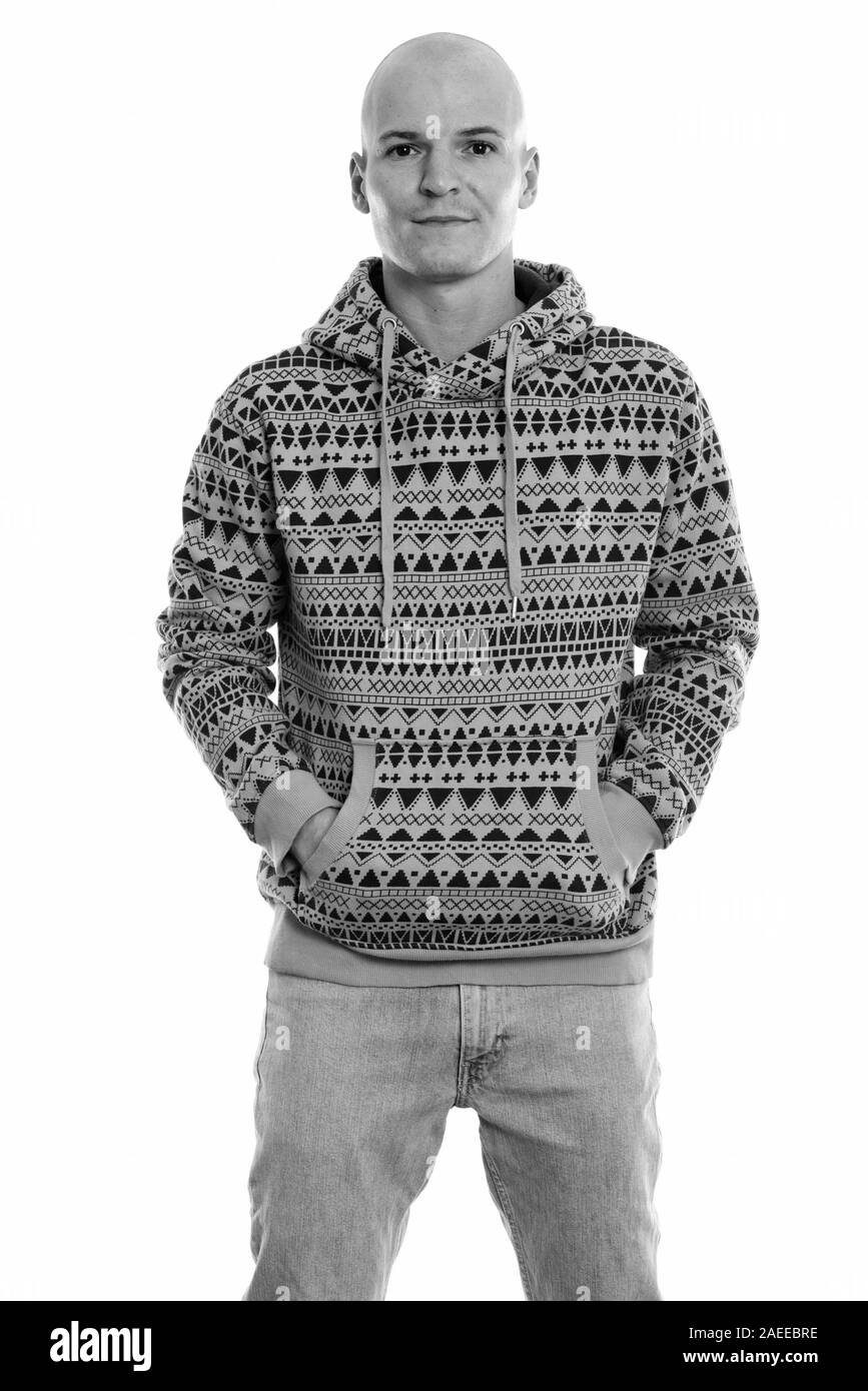 Studio shot of young handsome bald man standing Stock Photo - Alamy