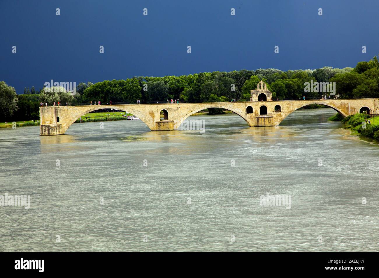 The Pont d'Avignon spanning part way across the Rhone River as a storm ...
