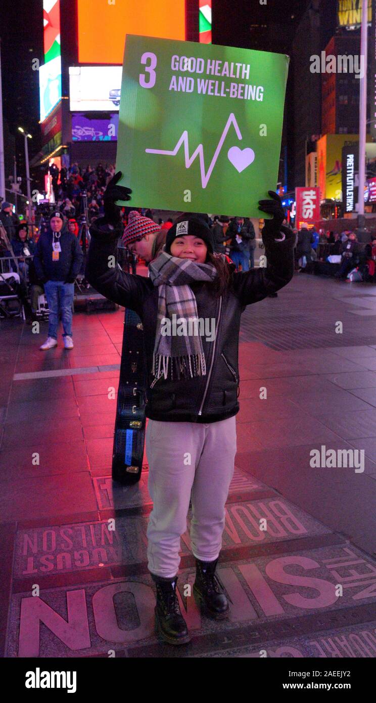 New York, NY - December 7, 2019: Participant holds sign with goal #3 of ...