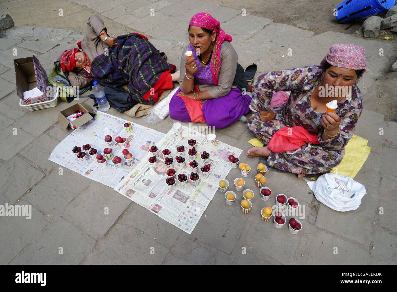 Cherry Plum Apricot fruit vendor eating ice cream, Manali, Himachal ...