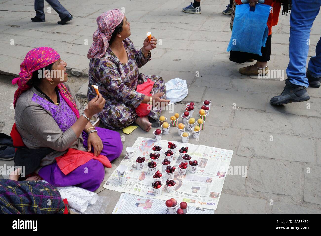 Cherry Plum Apricot fruit vendor eating ice cream, Manali, Himachal ...