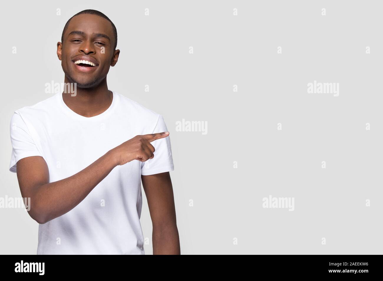 Happy African American man pointing finger at copy space Stock Photo ...