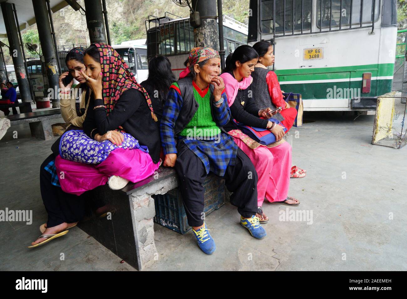 Himachali women waiting at bus stop, Banjar town, Tirthan Valley, Kullu ...