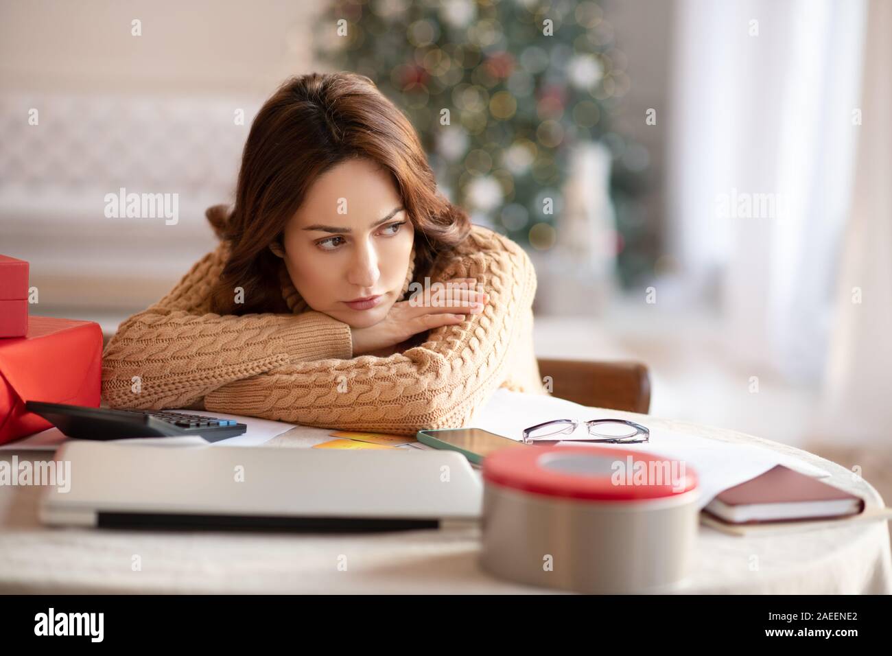 Cute woman in knitted sweater looking sad Stock Photo - Alamy