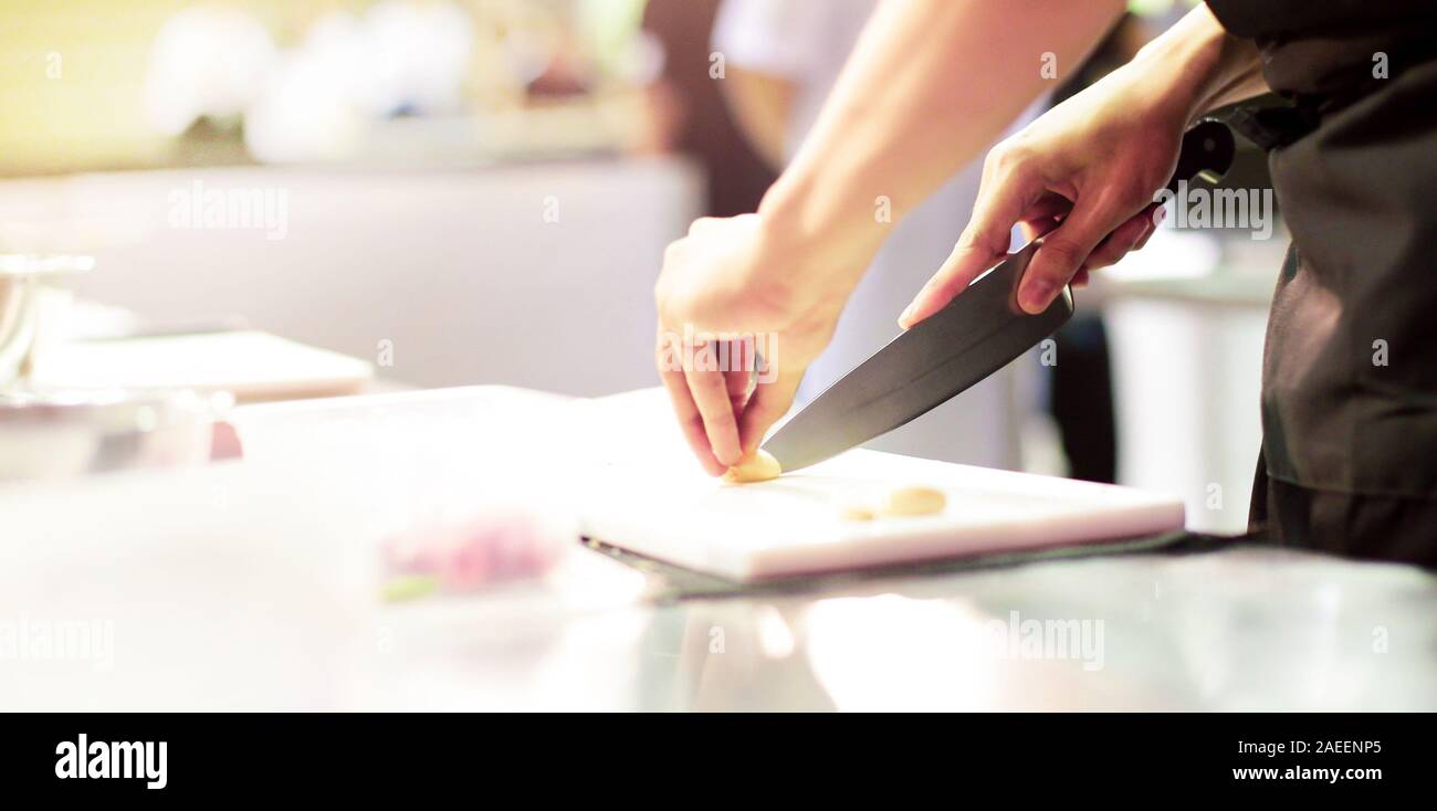 Chef cuts the vegetables cooking in a kitchen, hands slicing vegetables ...