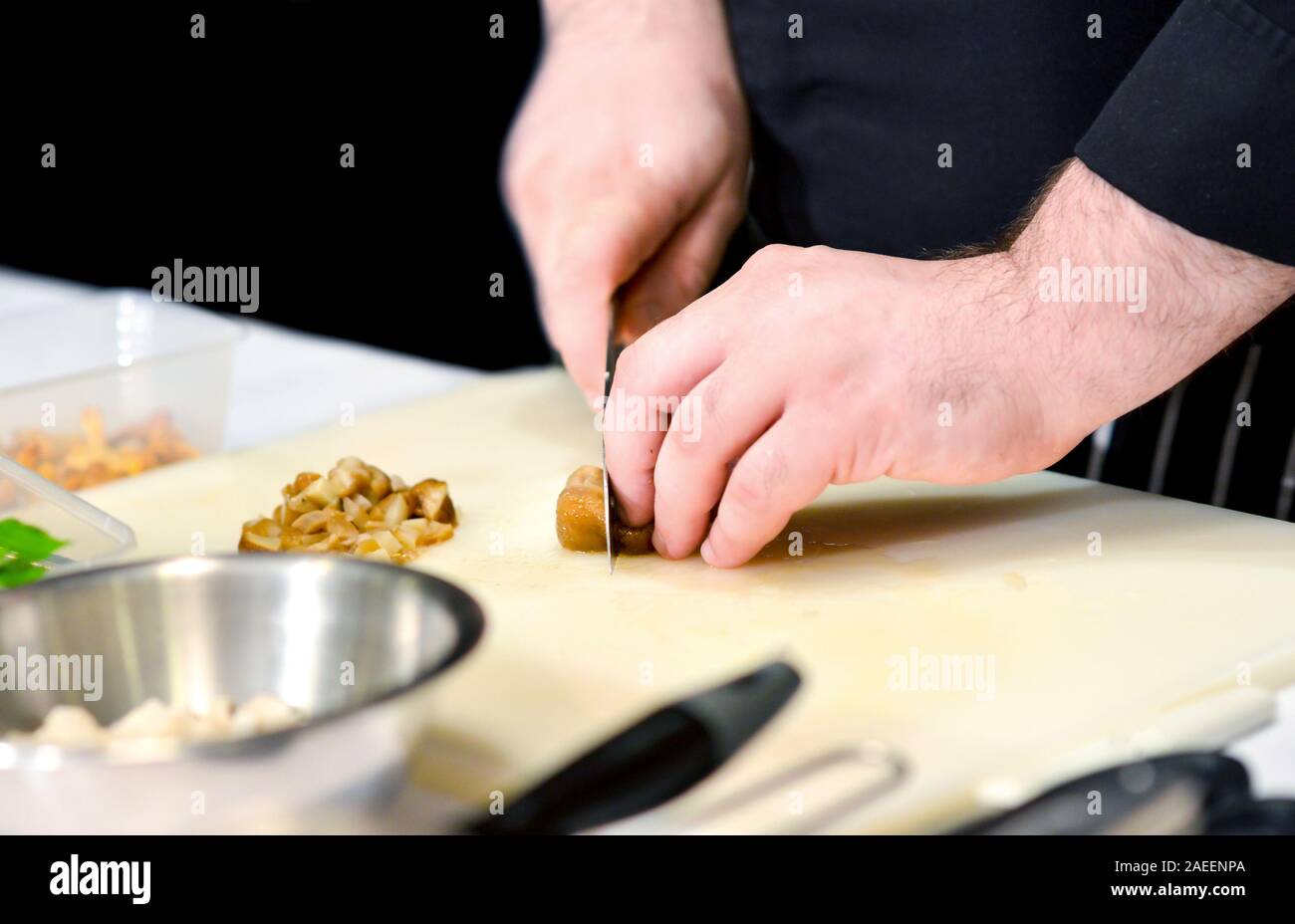 Chef cuts the vegetables cooking in a kitchen, hands slicing vegetables ...