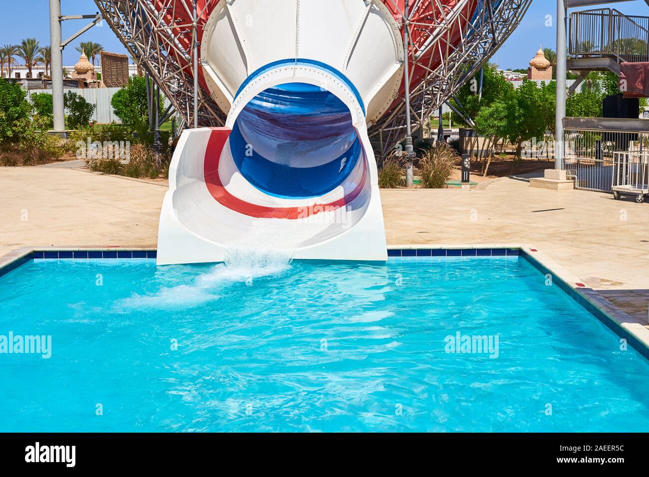 Colored water slide in water park with swimming pool Stock Photo - Alamy