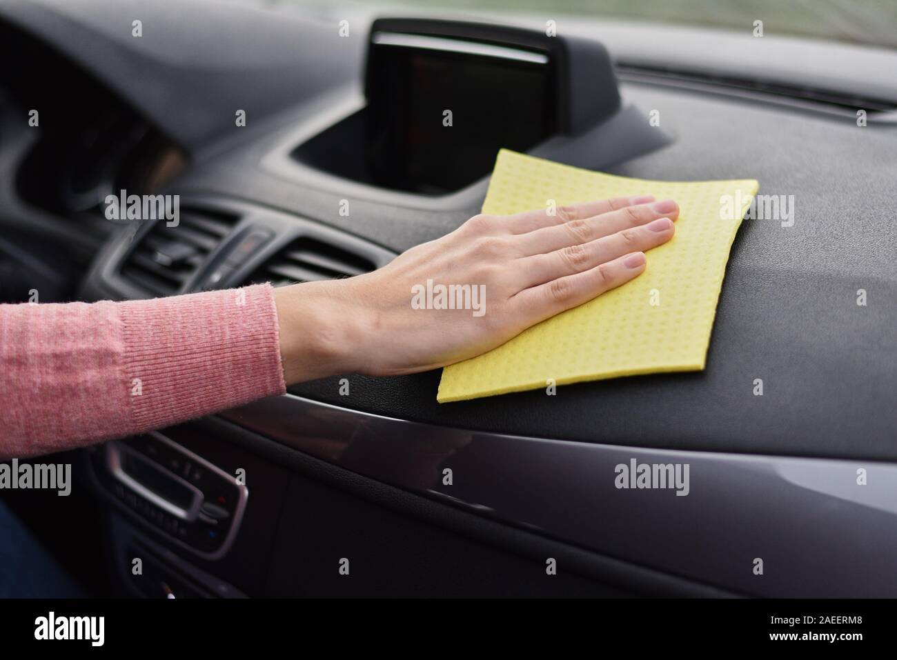 Woman hand cleanin car dashboard with yellow microfiber towel. Cleaning ...