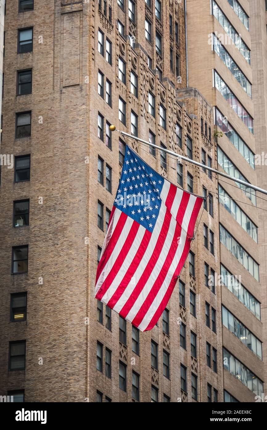 American flag with office building at the background. Manhattan ...