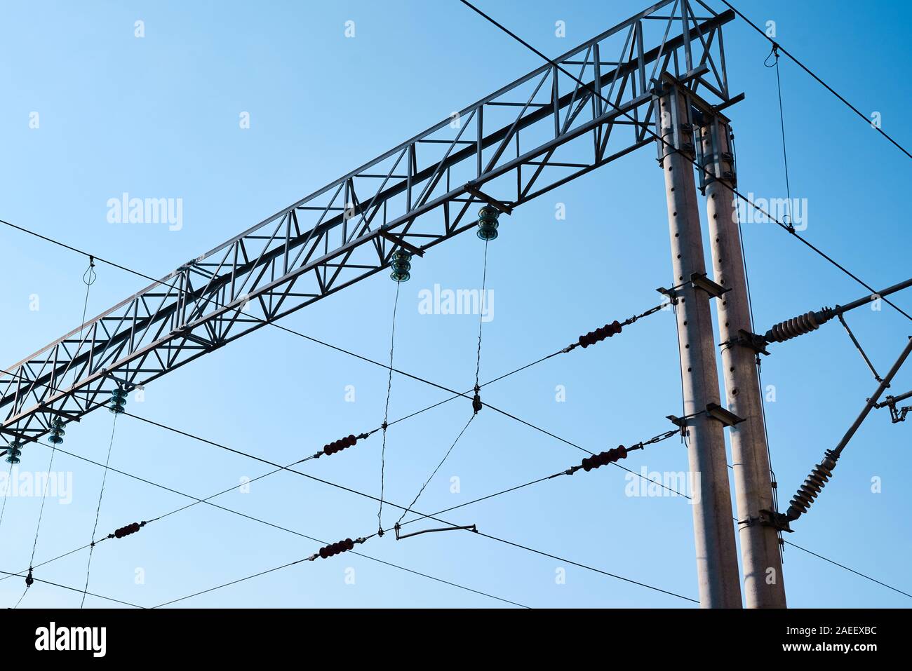 Power electricity wire for trains against blue sky. Close up of railway ...