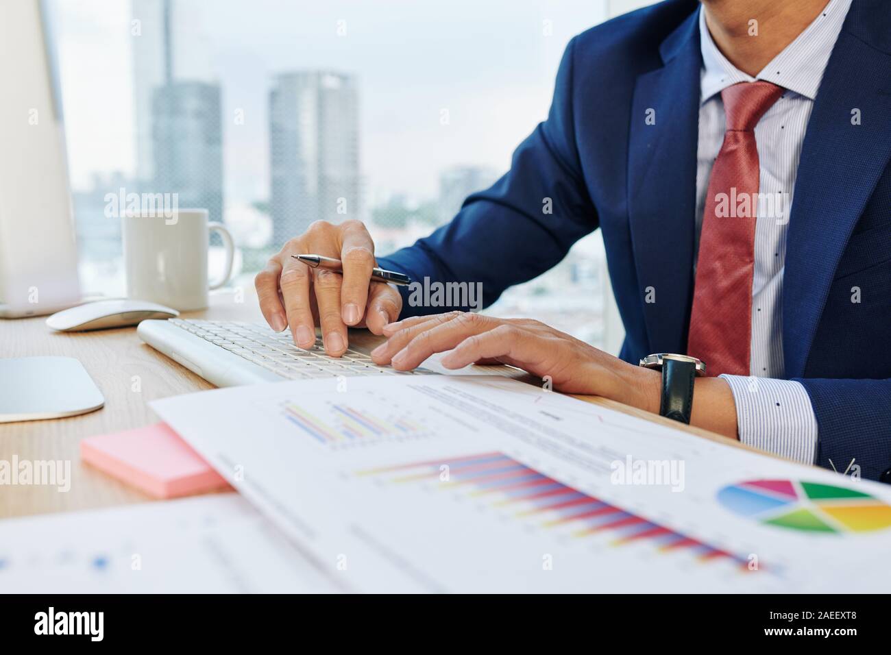 Hands of financial manager working on computer and checking annual ...