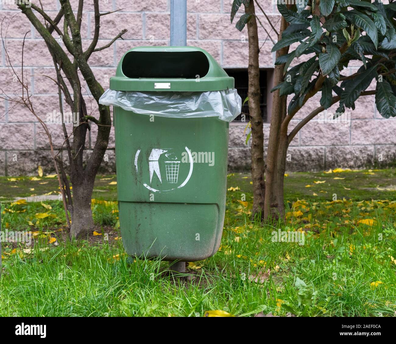 A little green dumpster of garbage empty Stock Photo - Alamy