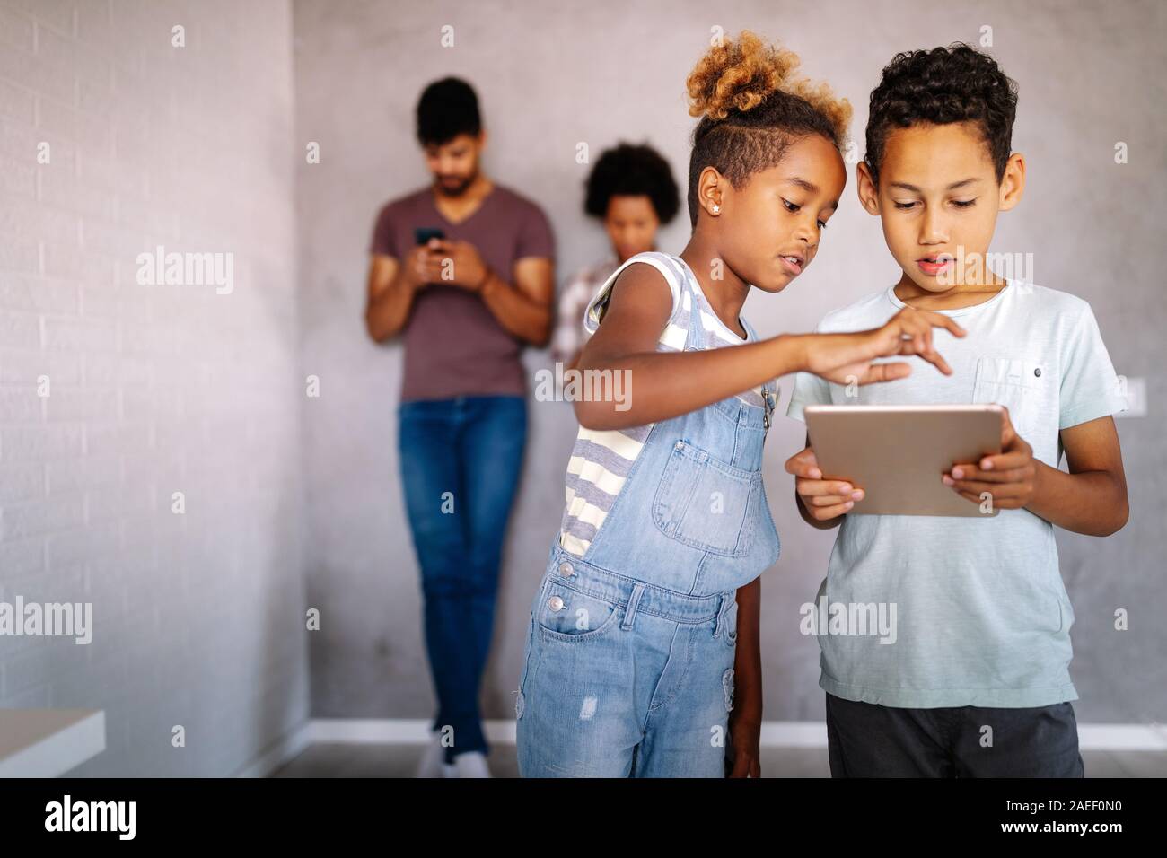 Happy children havig fun and using technology devices Stock Photo - Alamy