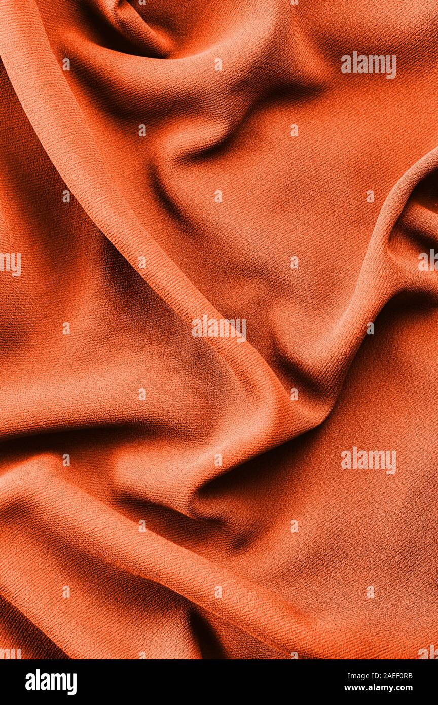 Abstract fabric texture. Trend shade of orange-red color. Top view ...