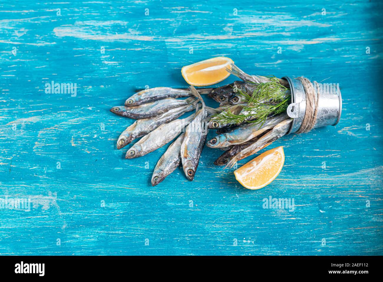 Small, salted fish. Near the slices of lemon. Sea fish. Copy space ...