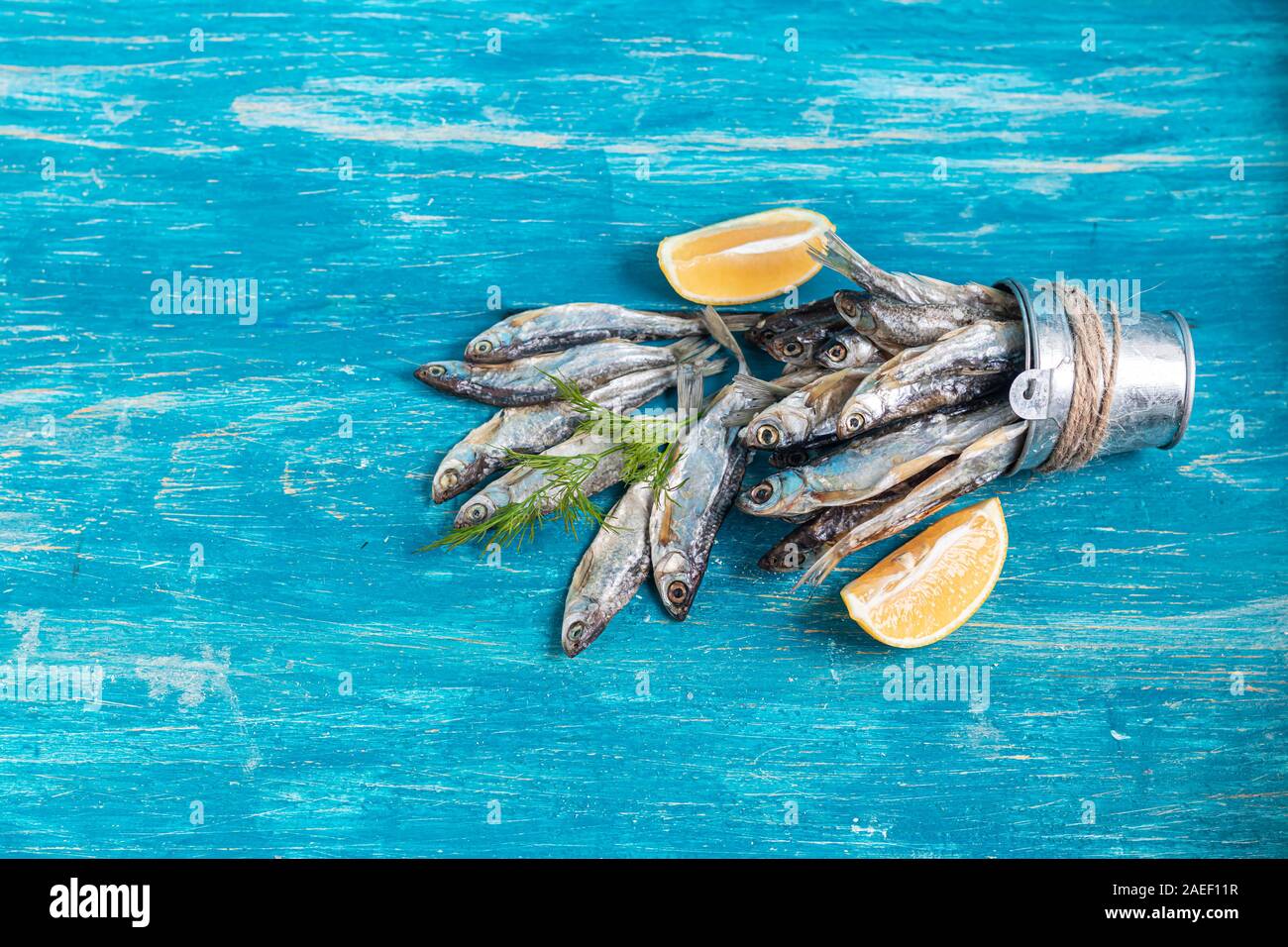 Small, salted fish. Near the slices of lemon. Sea fish. Copy space ...