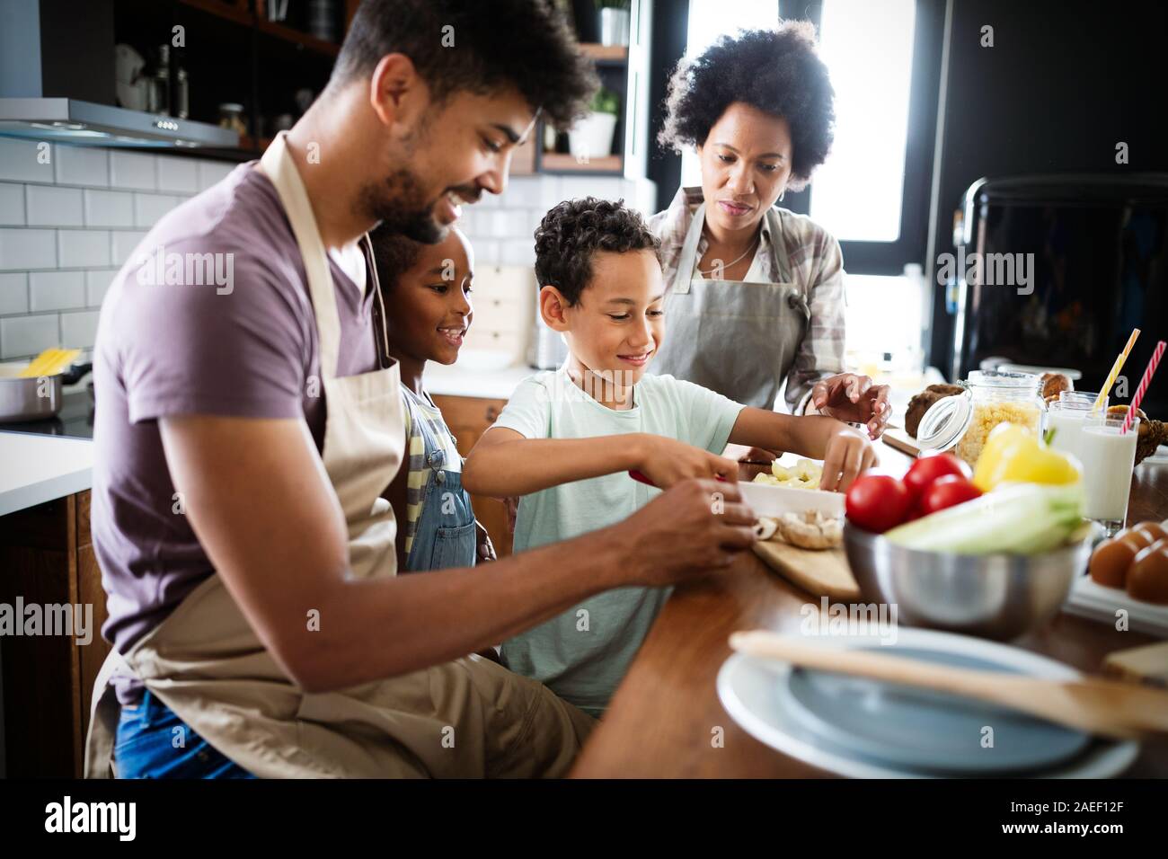 Happy family in the kitchen having fun and cooking together. Healthy ...