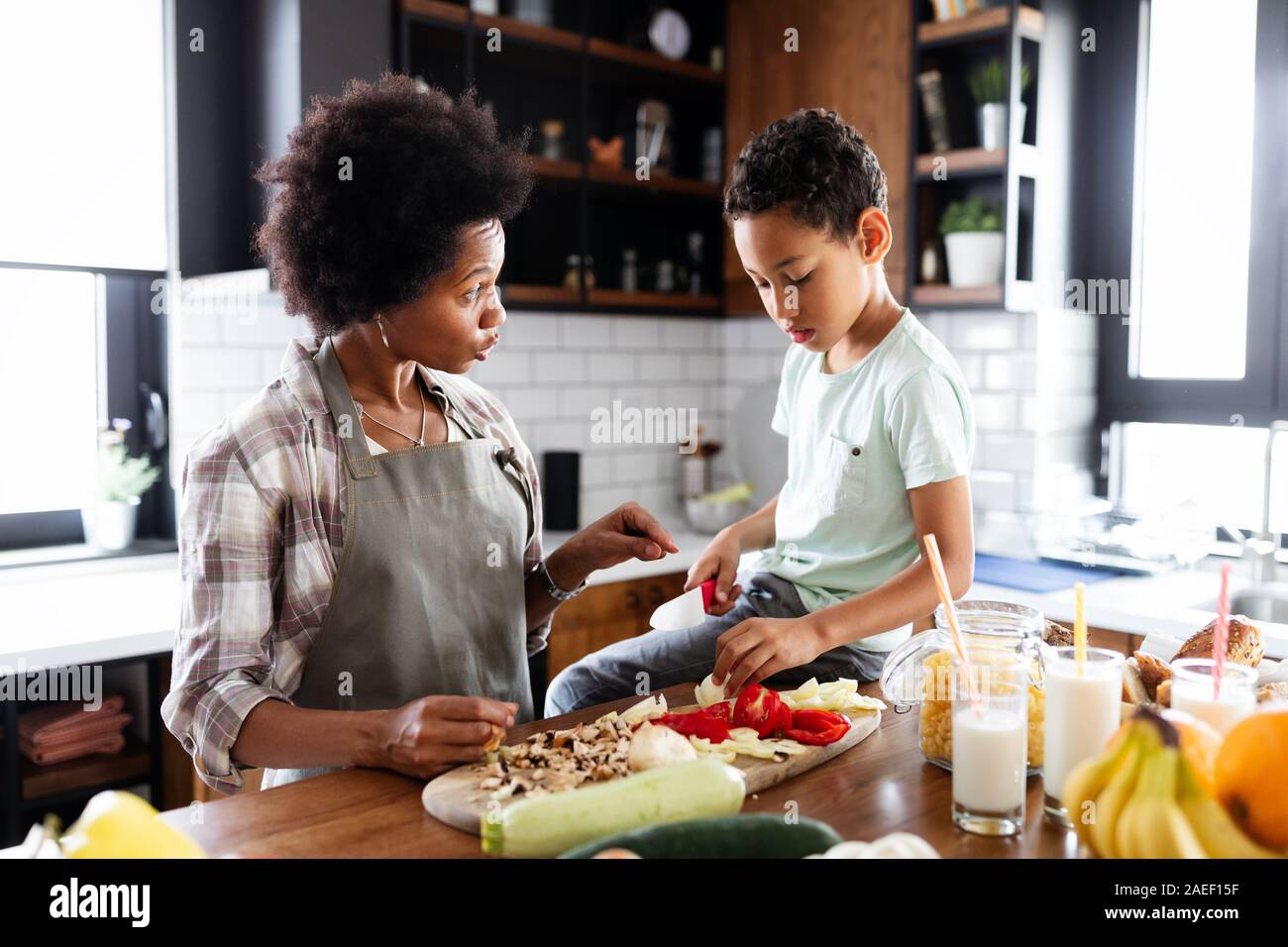 Happy mother and children in the kitchen. Healthy food, family, cooking ...