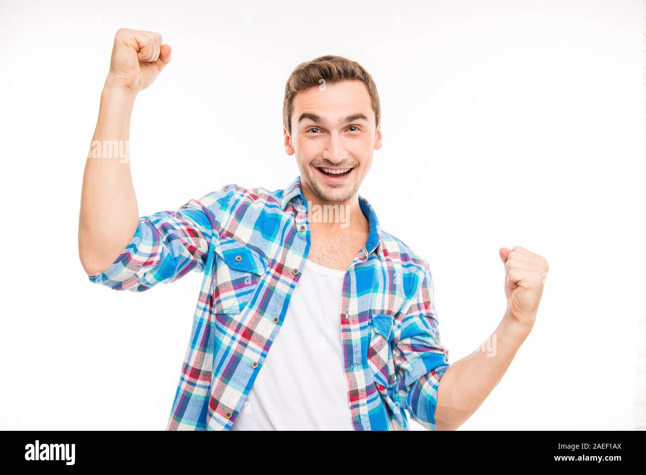 Confident cheerful handsome man lifting hands up Stock Photo - Alamy