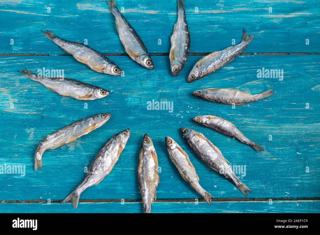 Small, salted fish. Near the slices of lemon. Sea fish. Copy space ...