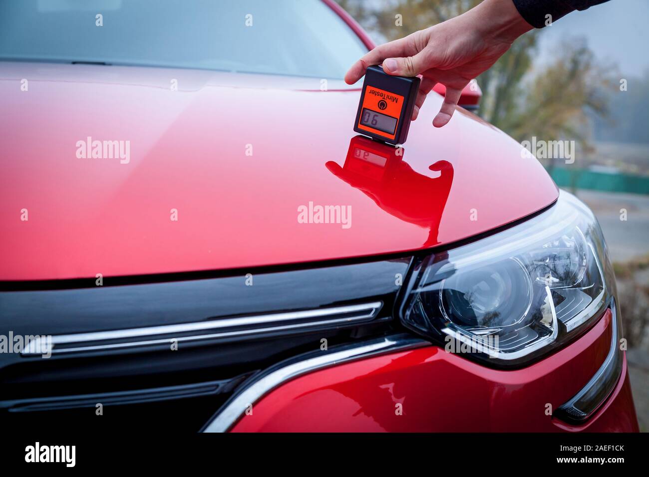Measuring the thickness of the car paint coating red color using a ...