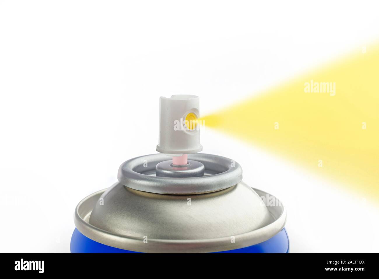 spray bottle spraying yellow color on white background Stock Photo - Alamy