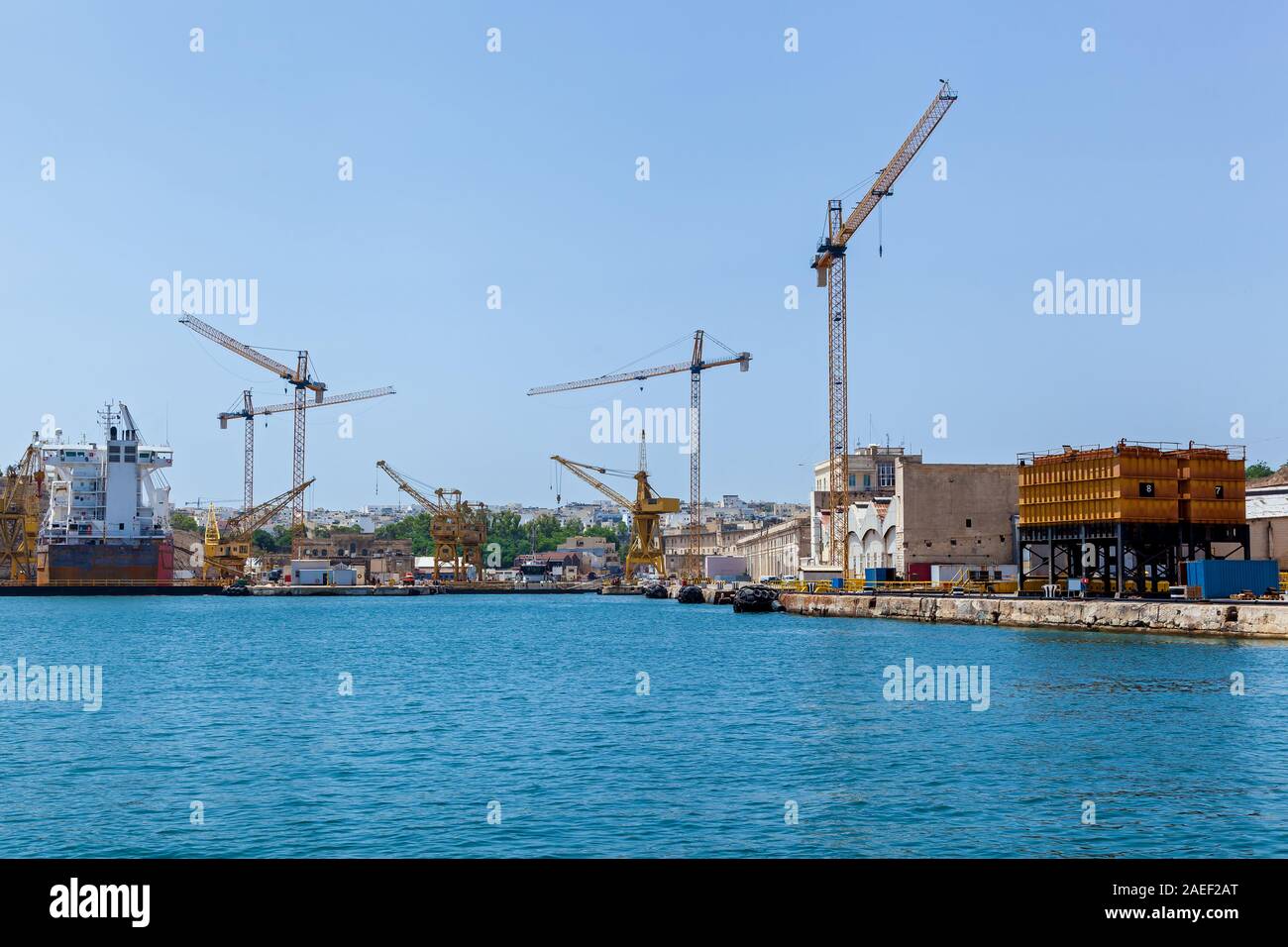 Colorful crane is placed on a floating dock in the harbor, Malta ...