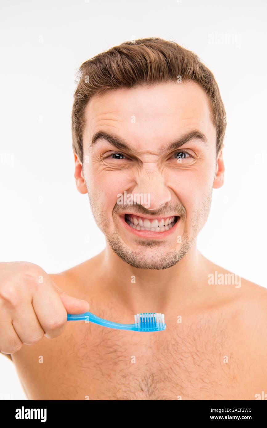 Funny young man holding toothbrush Stock Photo - Alamy