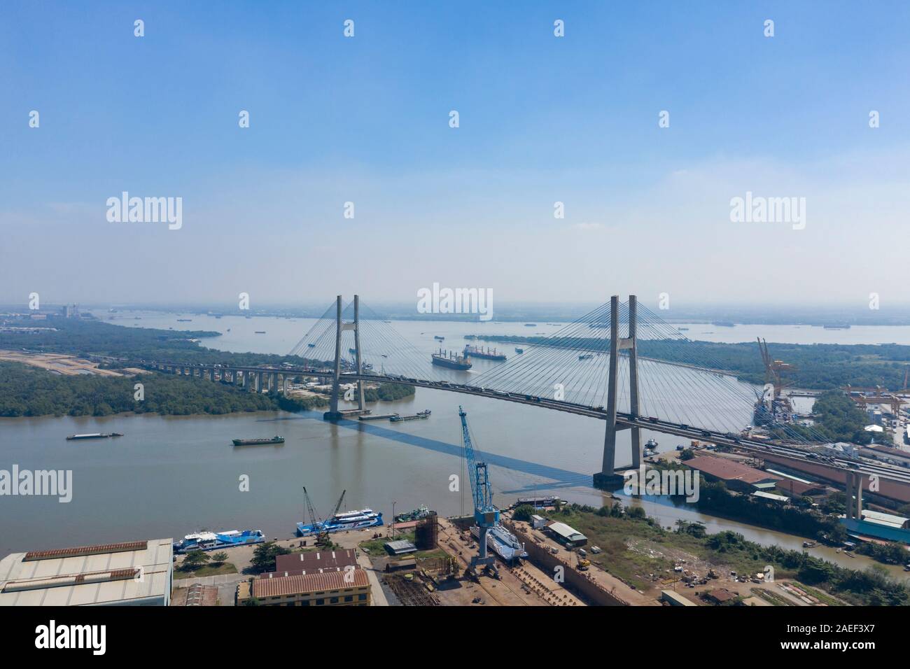 Drone shot of Phu My Bridge on a sunny day with blue sky with shipping ...