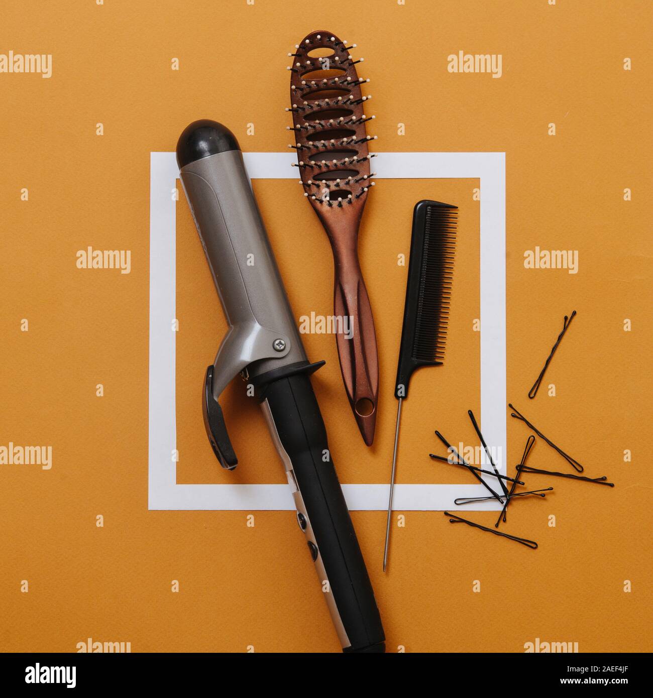 Barber tools: curling iron, hairbrush, rat tail comb, bobby pins over ...