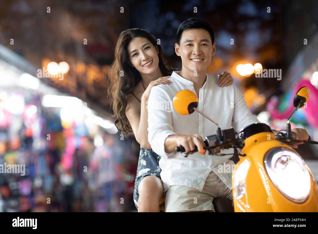 Happy young couple riding motorcycle together Stock Photo - Alamy