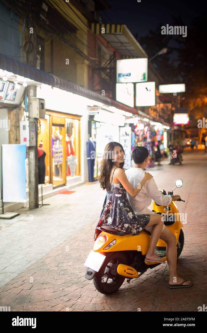 Happy young couple riding motorcycle together Stock Photo - Alamy