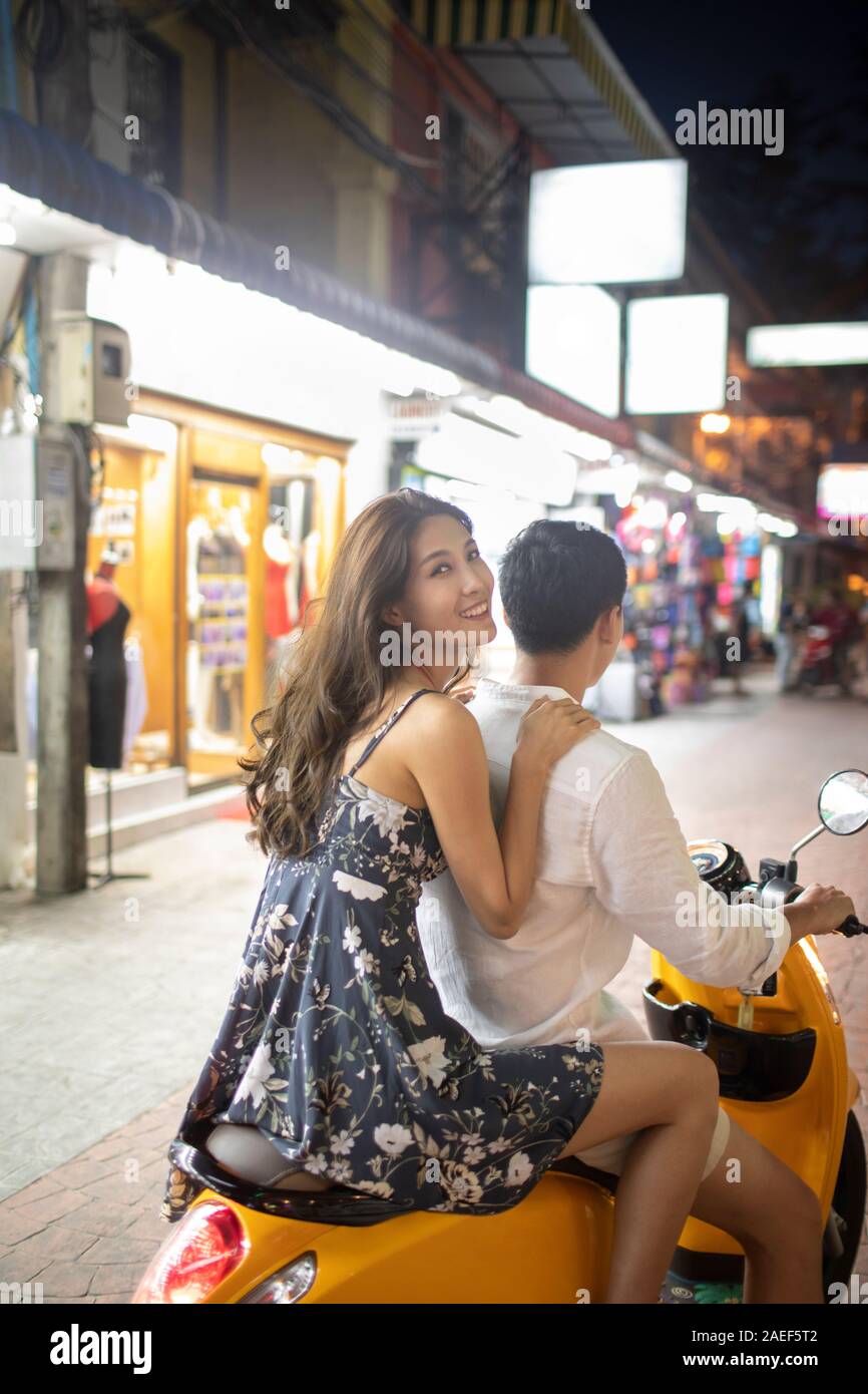 Happy young couple riding motorcycle together Stock Photo - Alamy